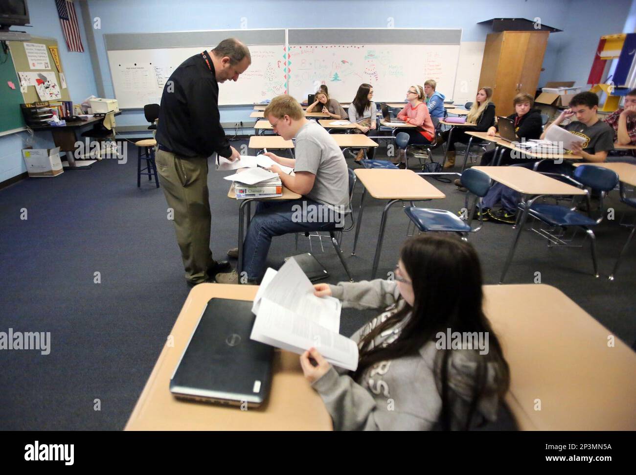 Jeff Swisher talks to student Andrew Blonn, 15 during his Topics in ...