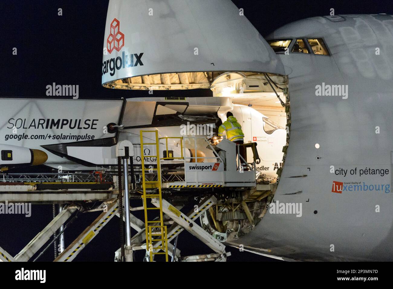Solar Impulse crew members load the experimental aircraft "Solar ...
