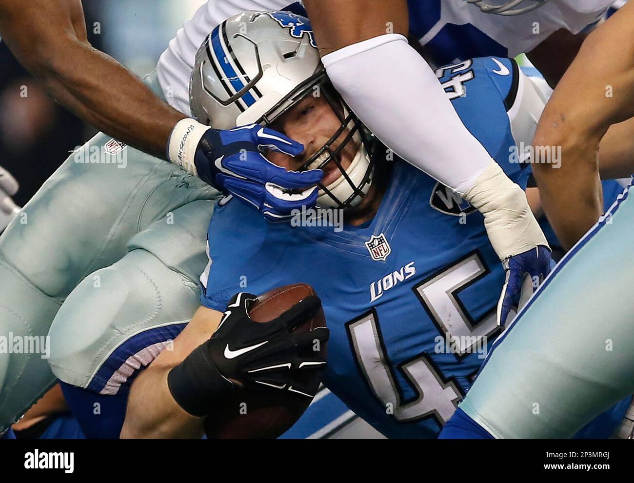 Detroit Lions fullback Jed Collins (45) is grabbed in the face mask by ...