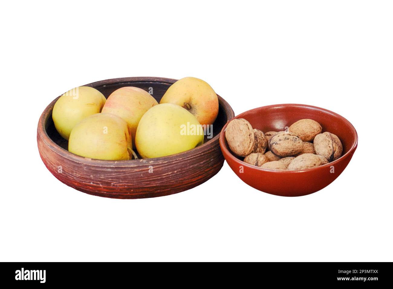 Apples and walnuts in a bowl, isolated on a white background. Rural ...