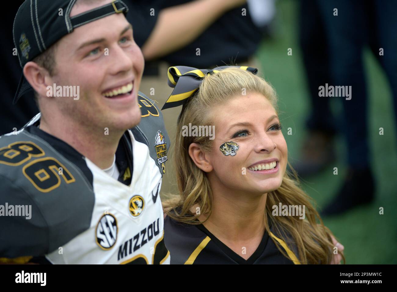 A Missouri cheerleader stands with tight end Jake Hurrell (86) on the ...
