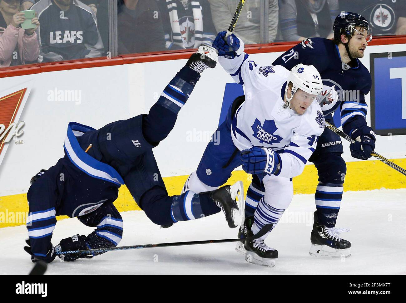 Toronto Maple Leafs' Morgan Rielly (44) checks Winnipeg Jets' Matt ...