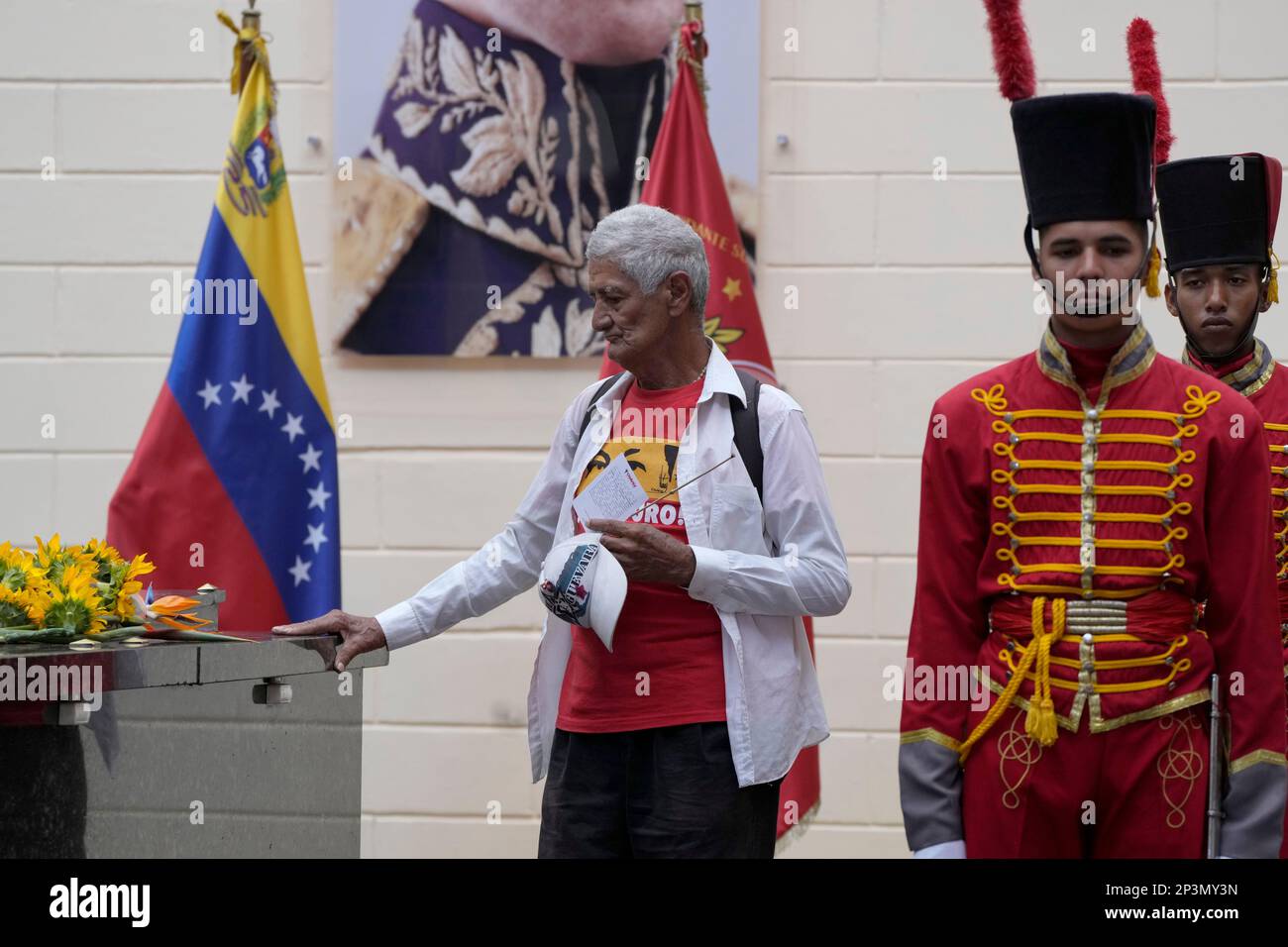A visitor touches the tomb of late Venezuelan President Hugo Chavez ...
