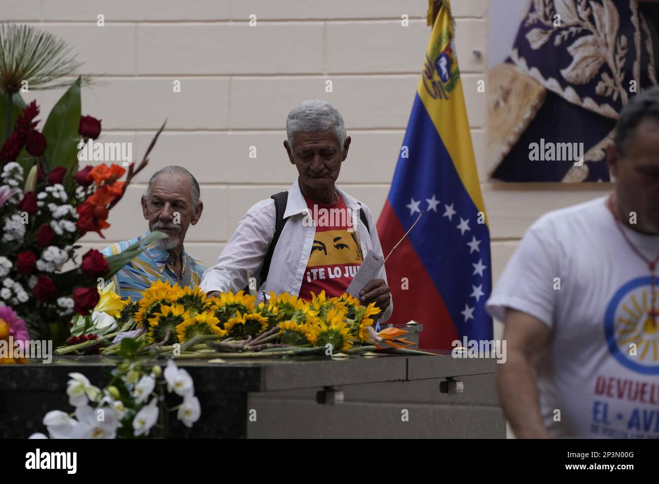 Visitors pay their respects as they walk past the tomb of late ...