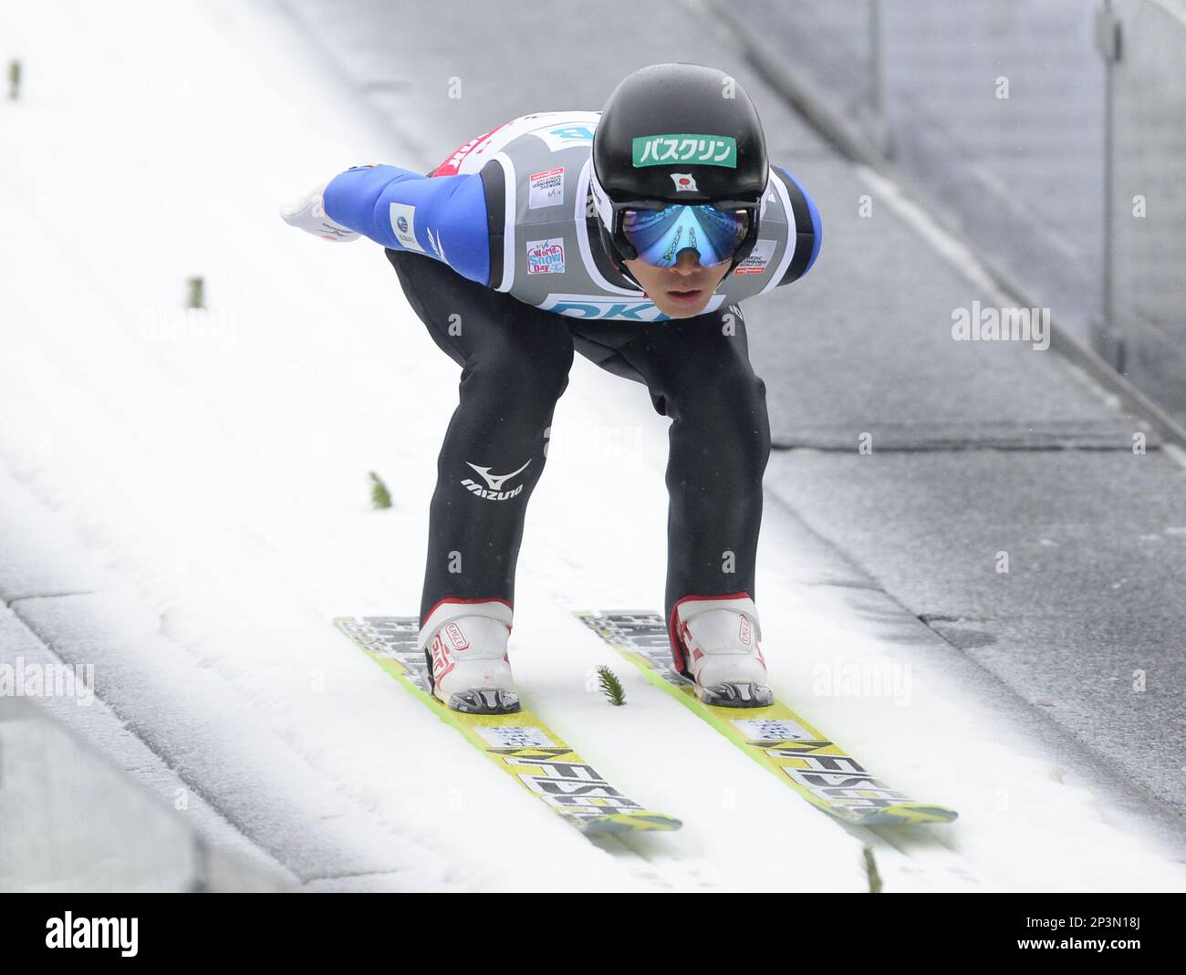 Akito Watabe from Japan races down the hill during the ski jumping of ...