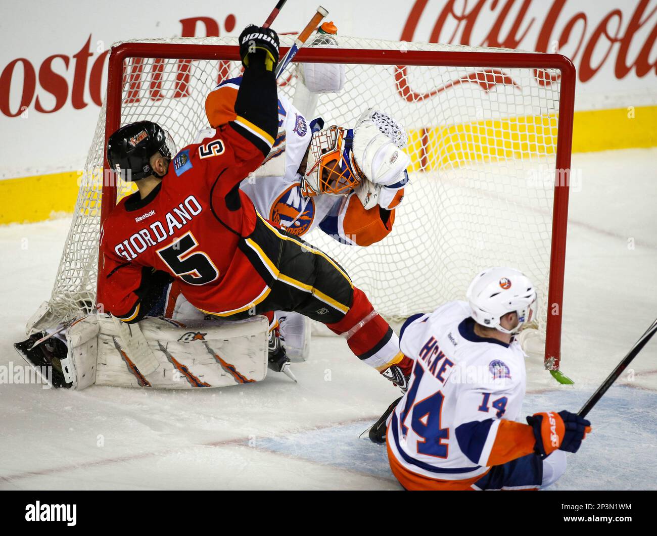 New York Islanders Thomas Hickey, right, checks Calgary Flames Mark ...