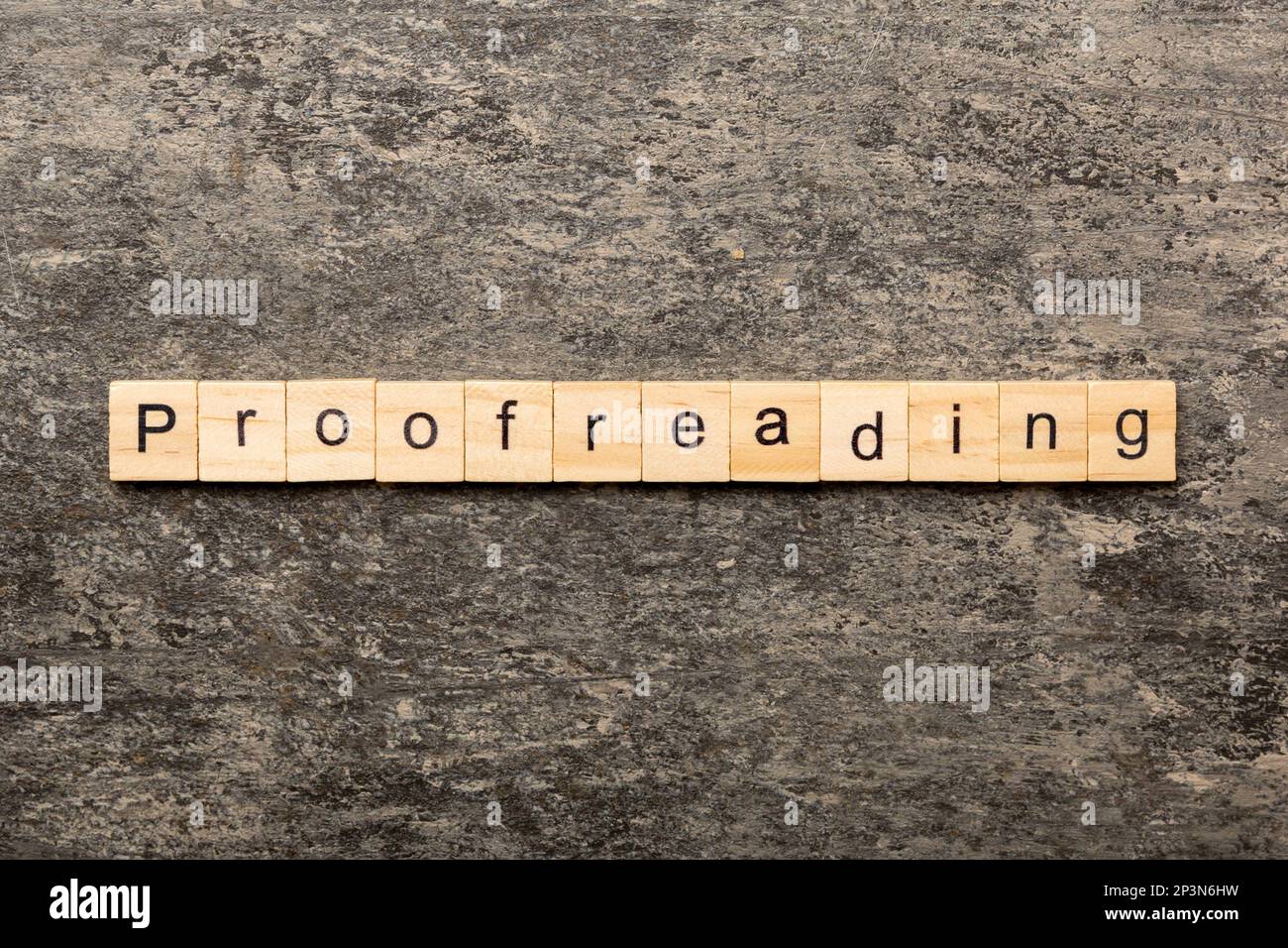 proofreading word written on wood block. proofreading text on table ...