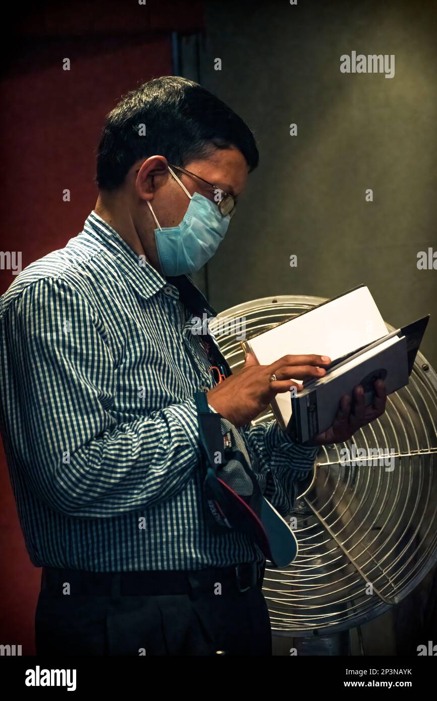 Kolkata, India - February 12, 2023: A side portrait of a man engrossed ...