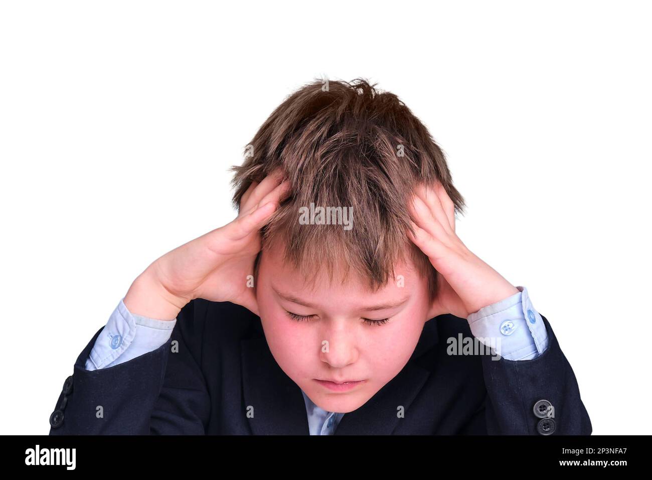 A sad boy in a school suit on distance learning, isolated on a white ...