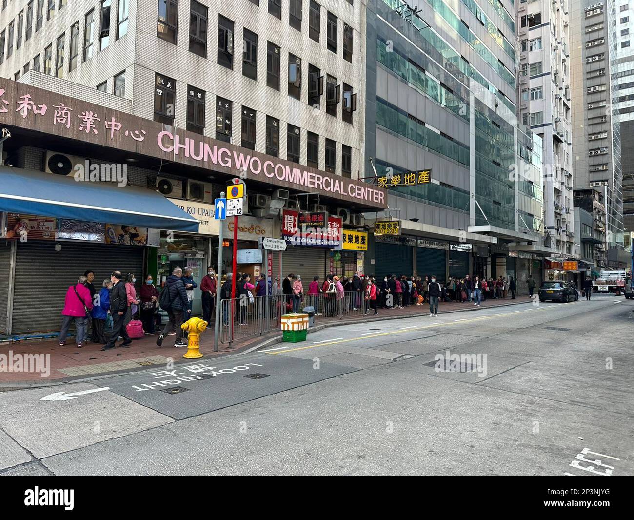 Residents queue to get into the Tsim Sha Tsui District Kaifong Welfare ...