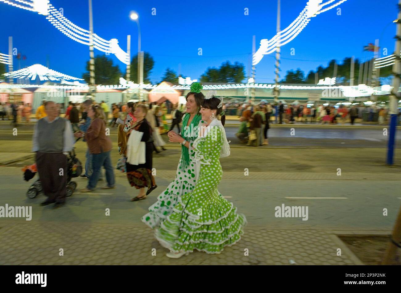 Feria de Abril (The April Fair). "El Real". Women wearing traditional ...