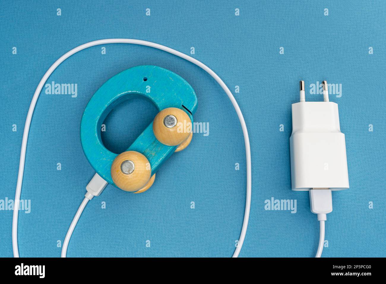 phone charger is connected to a children's car on a blue background ...