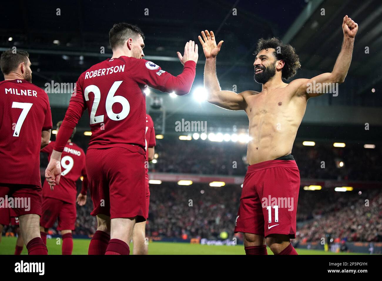 Liverpool's Mohamed Salah (right) celebrates scoring their side's sixth ...