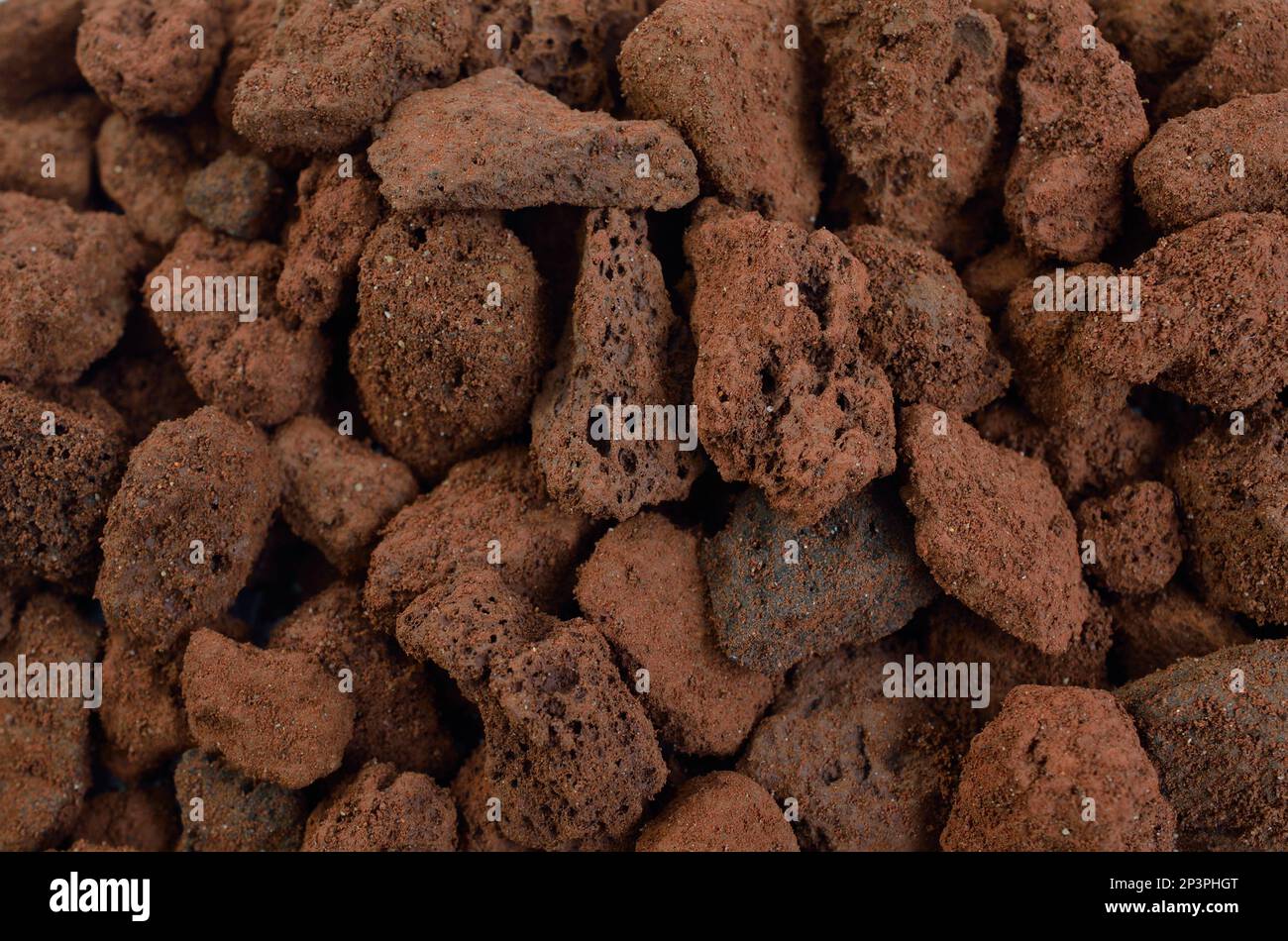 Porous brown volcanic rock isolated on white background. Lava stone ...