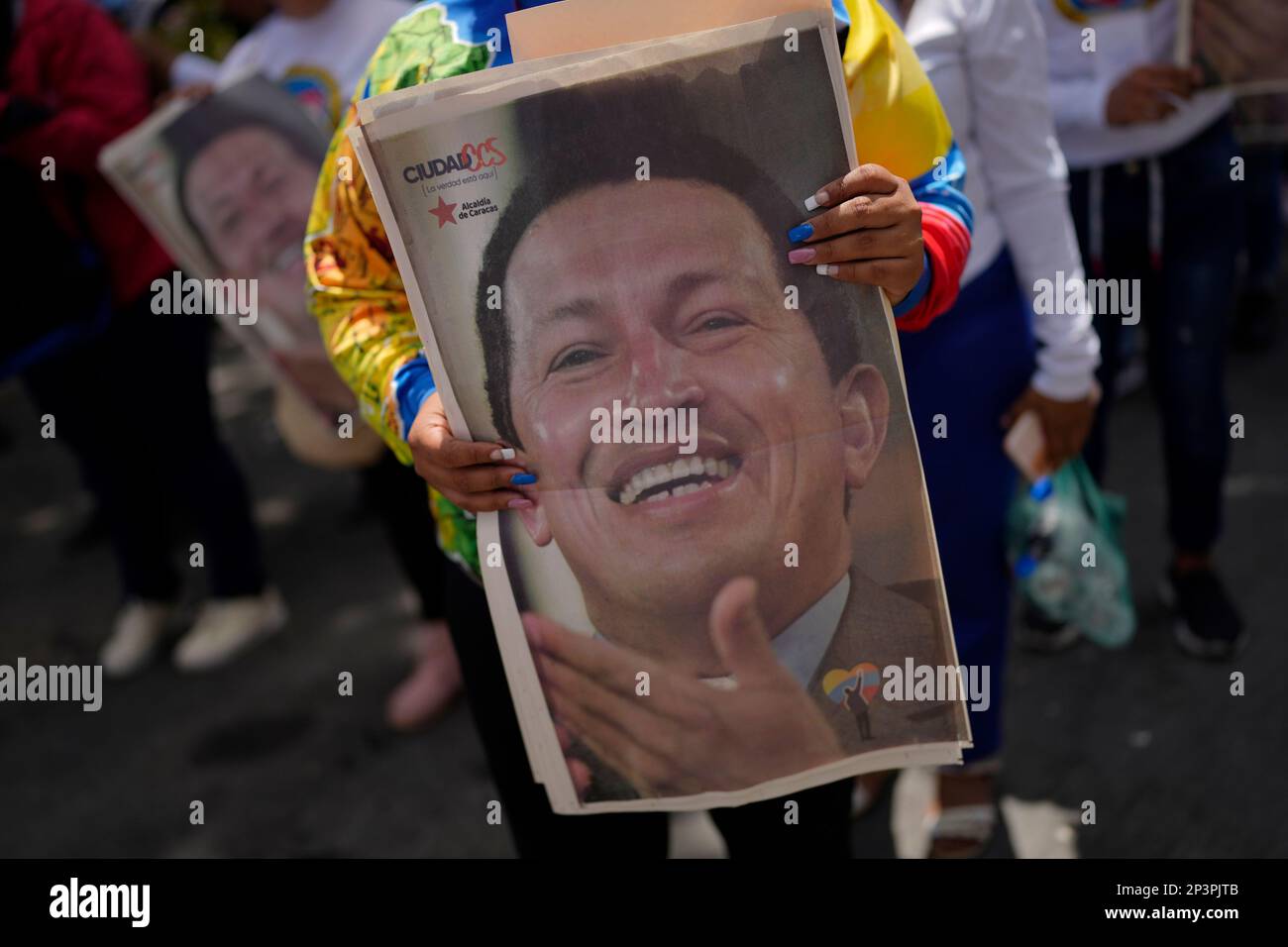 A visitor holds a poster with the image of late Venezuelan President ...