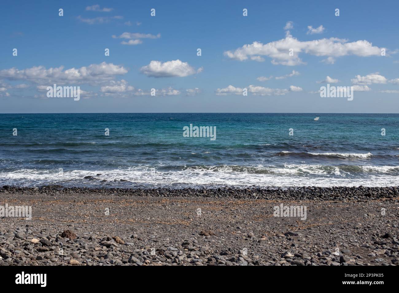 Sunny day in the winter. Coast of the Atlantic ocean with small waves ...