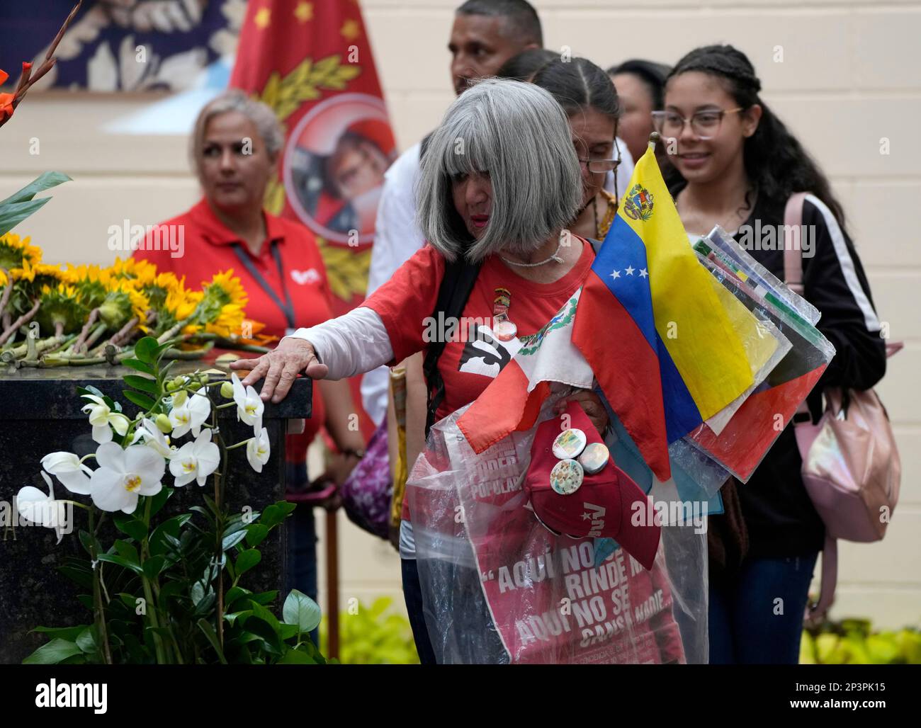 A visitor touches the tomb of late Venezuelan President Hugo Chavez ...