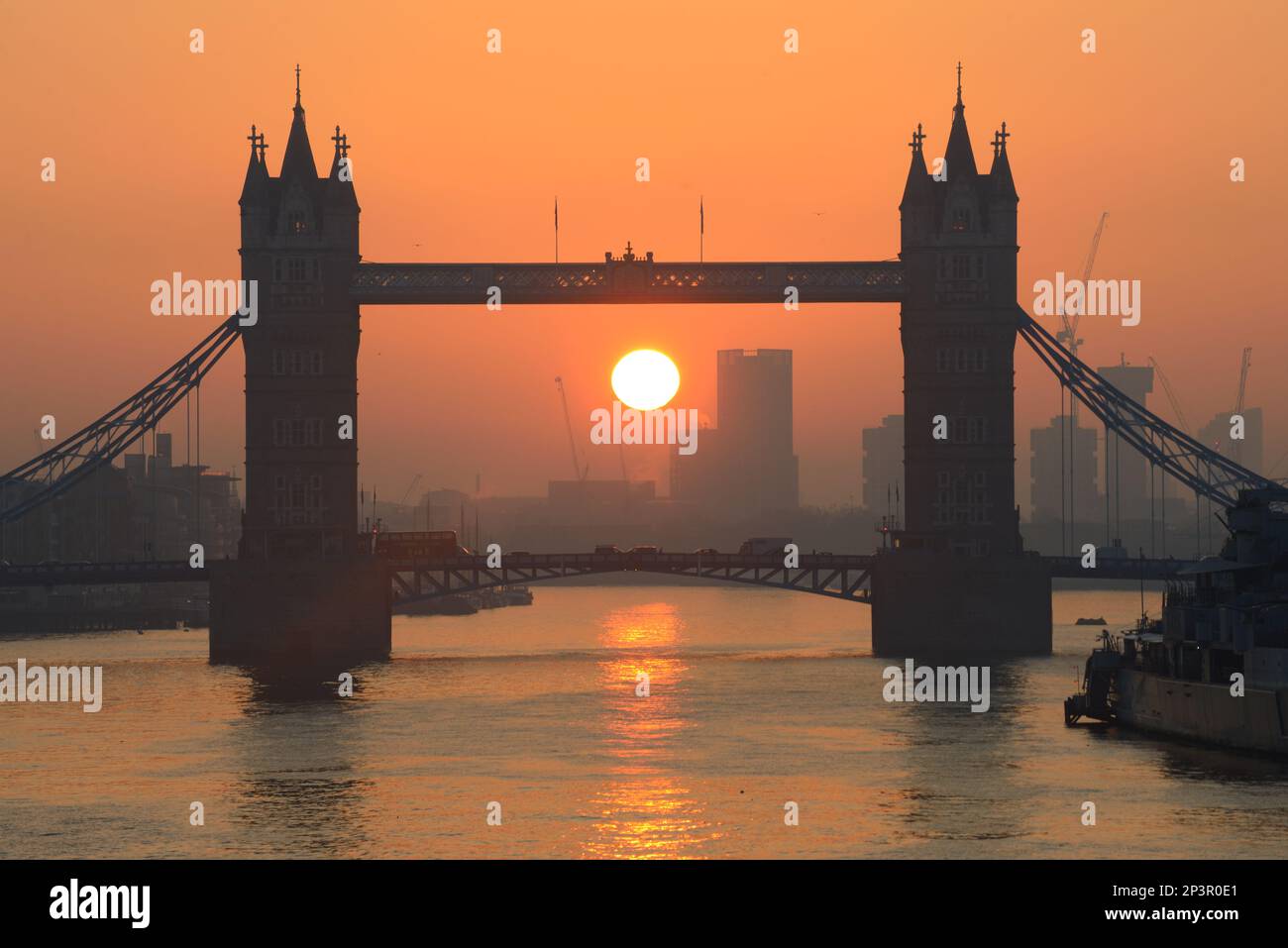 Tower bridge and museum ship hms belfast at sunrise hi-res stock ...
