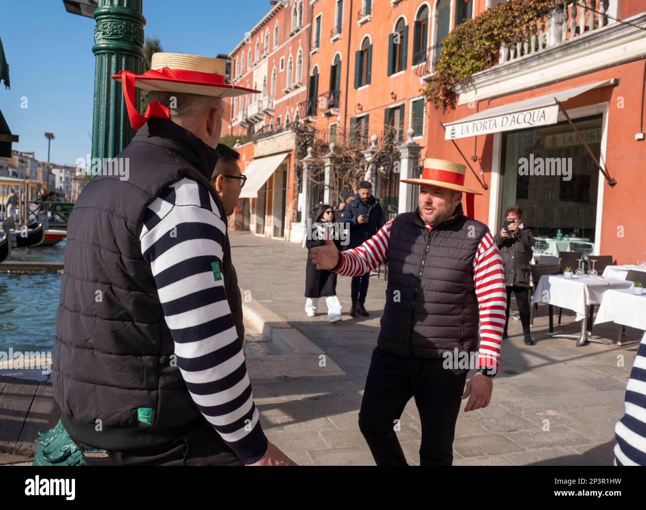 Gondoliers at San Silvestro chat before starting work on the Grand ...