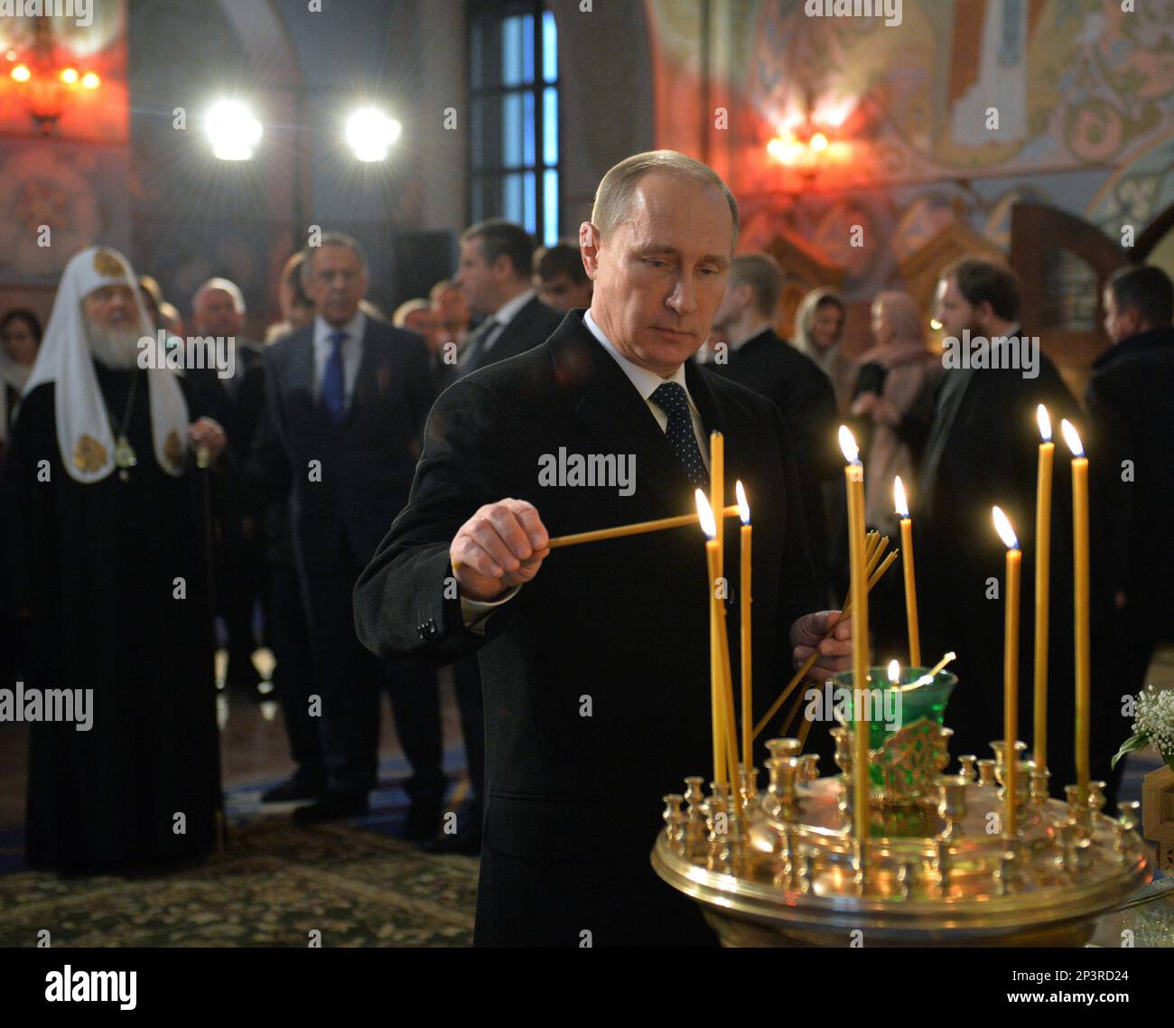 Russian President Vladimir Putin lights a candle during a visit to St ...