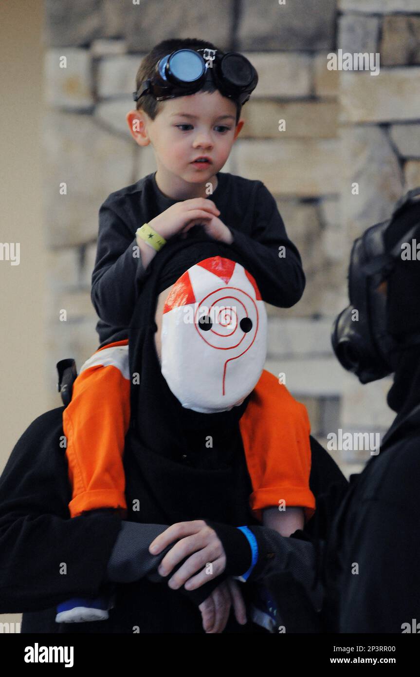 Ron Baird, gives his son Jackson, 4, a ride on his shoulders so he can ...