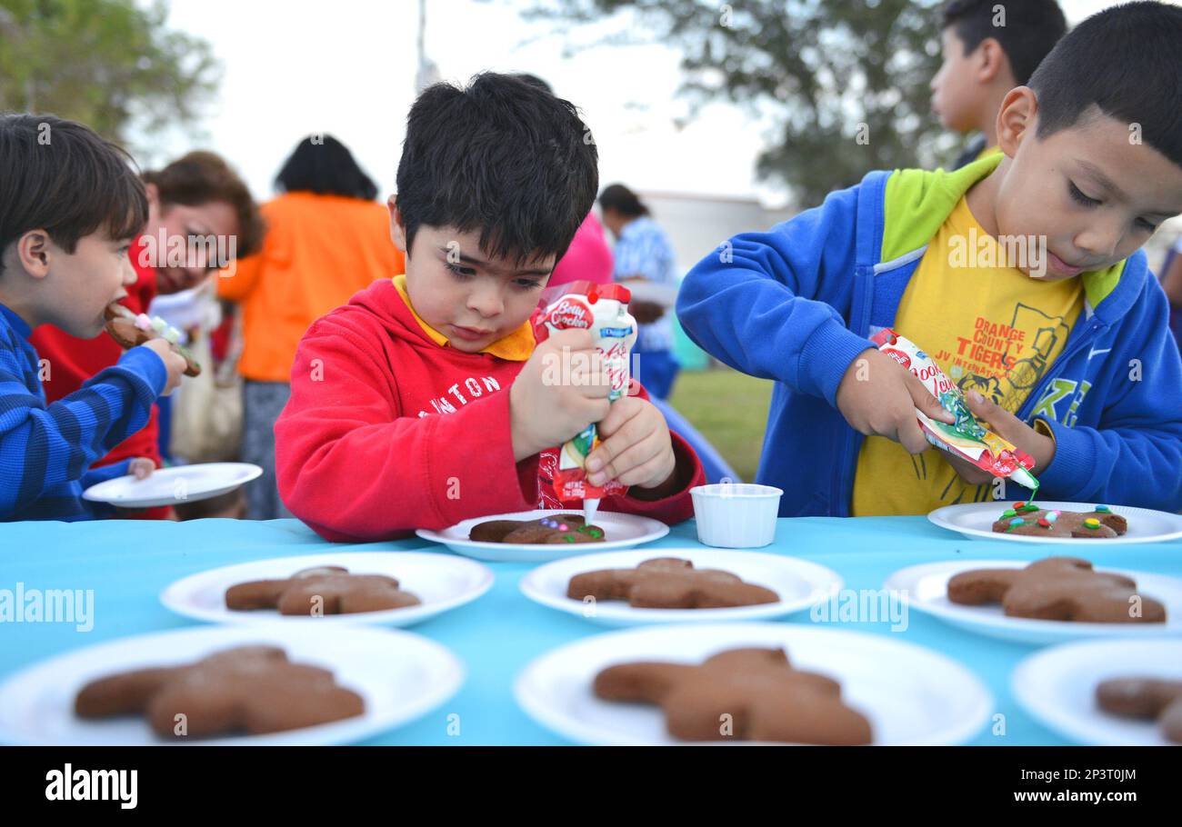 Six-year-old Kevin Vasquez,left, and Ariel Hernandez make gingerbread ...