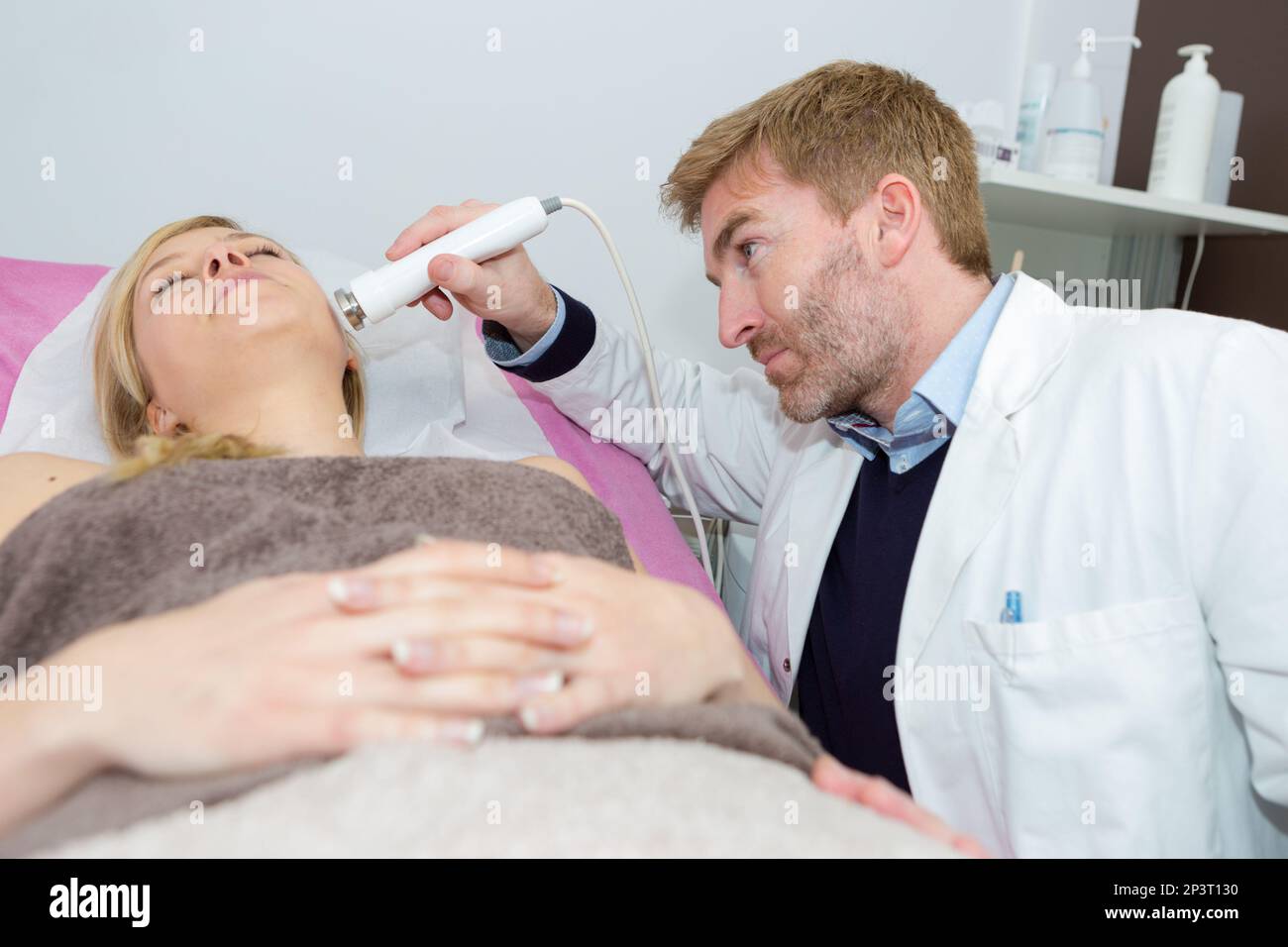 carrying an ultrasound test on female patient Stock Photo - Alamy