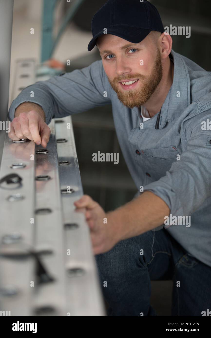 maintenance worker man carrying aluminium step ladder Stock Photo - Alamy