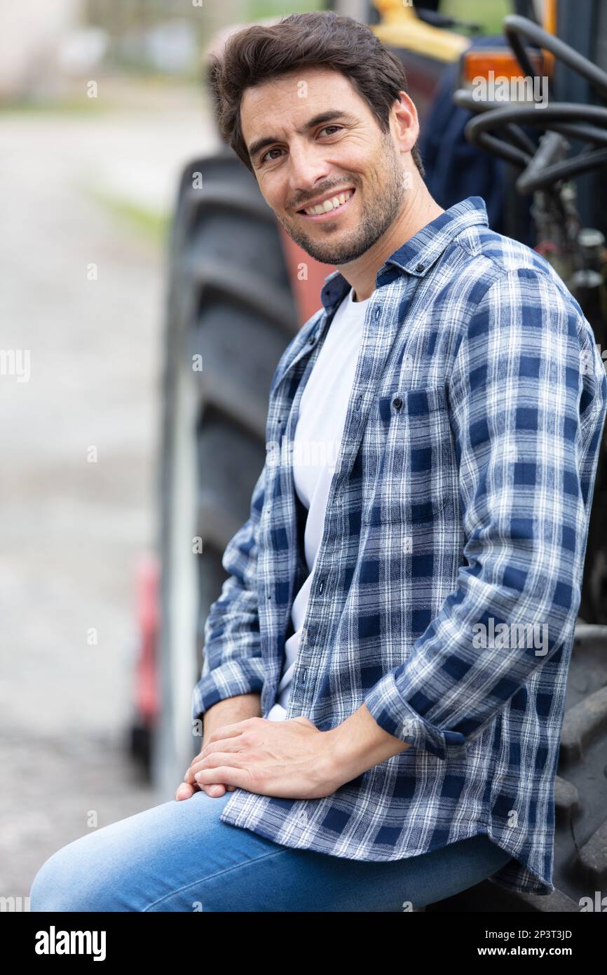 farmer standing by tractor outside the barn Stock Photo - Alamy