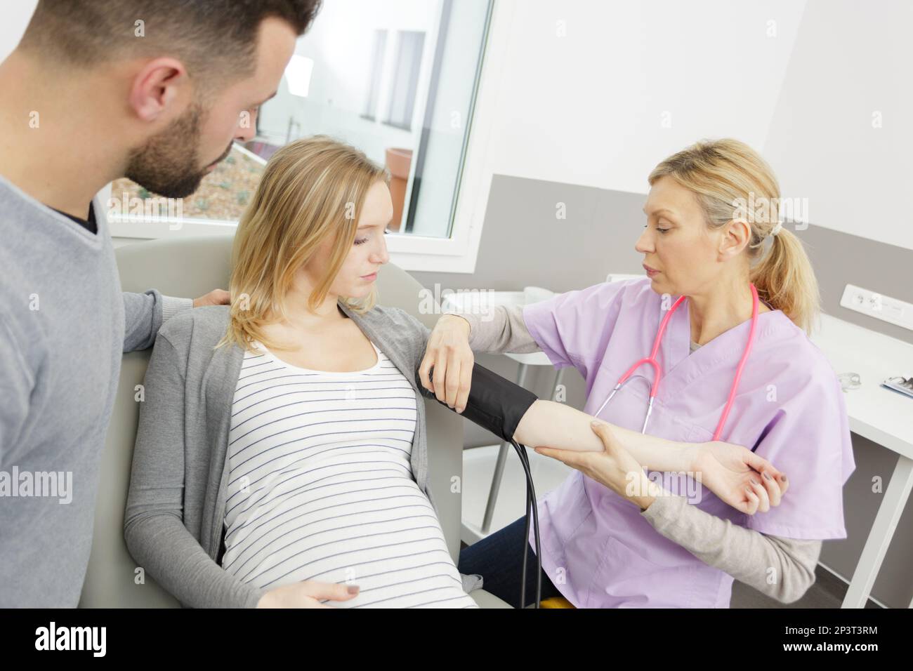 nurse checking blood pressure of a pregnant woman Stock Photo - Alamy