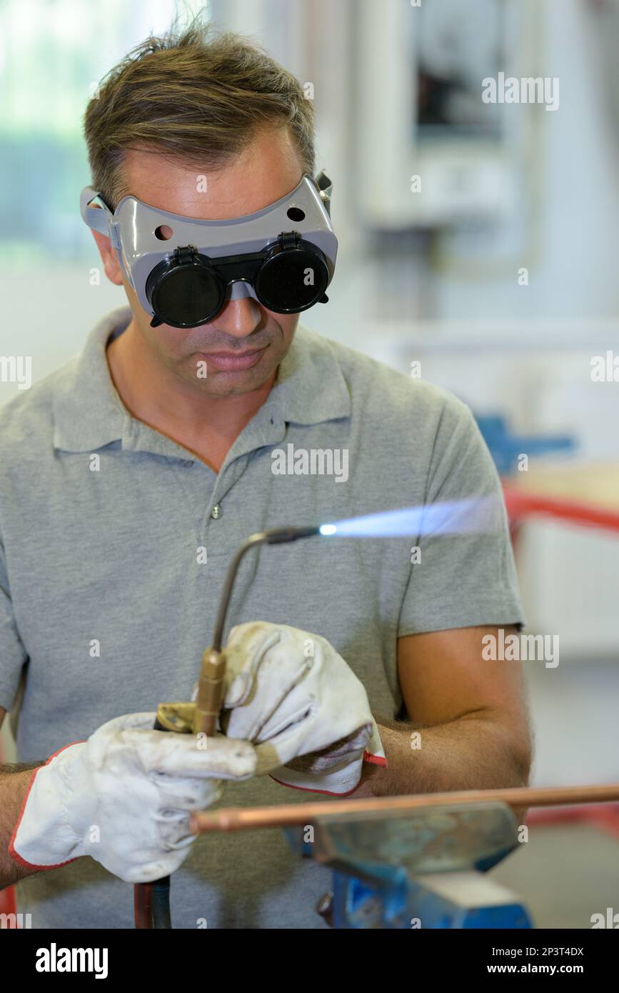 welding man welding pipe in industry Stock Photo - Alamy