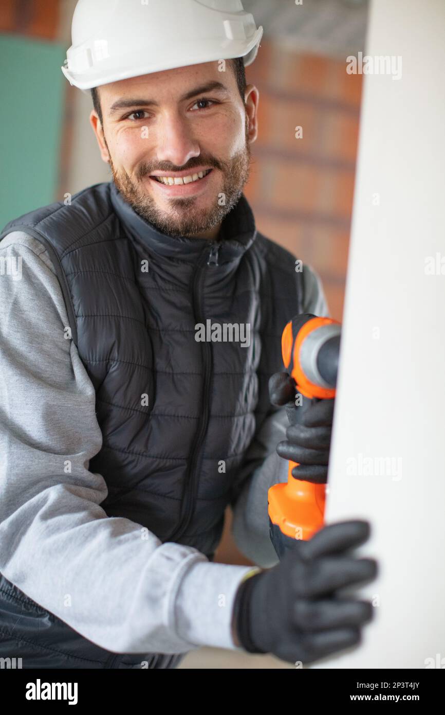 portrait of workman using a cordless drill Stock Photo - Alamy