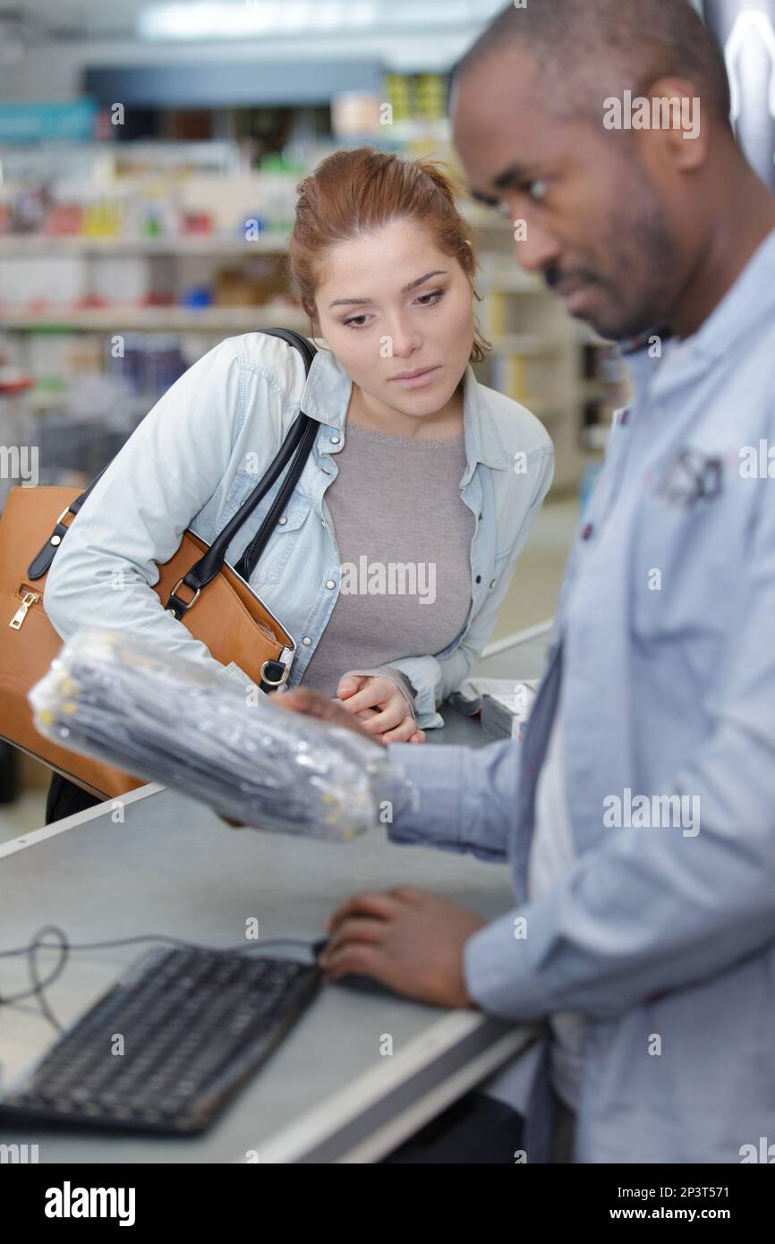 man warehouse worker talking to customer Stock Photo - Alamy