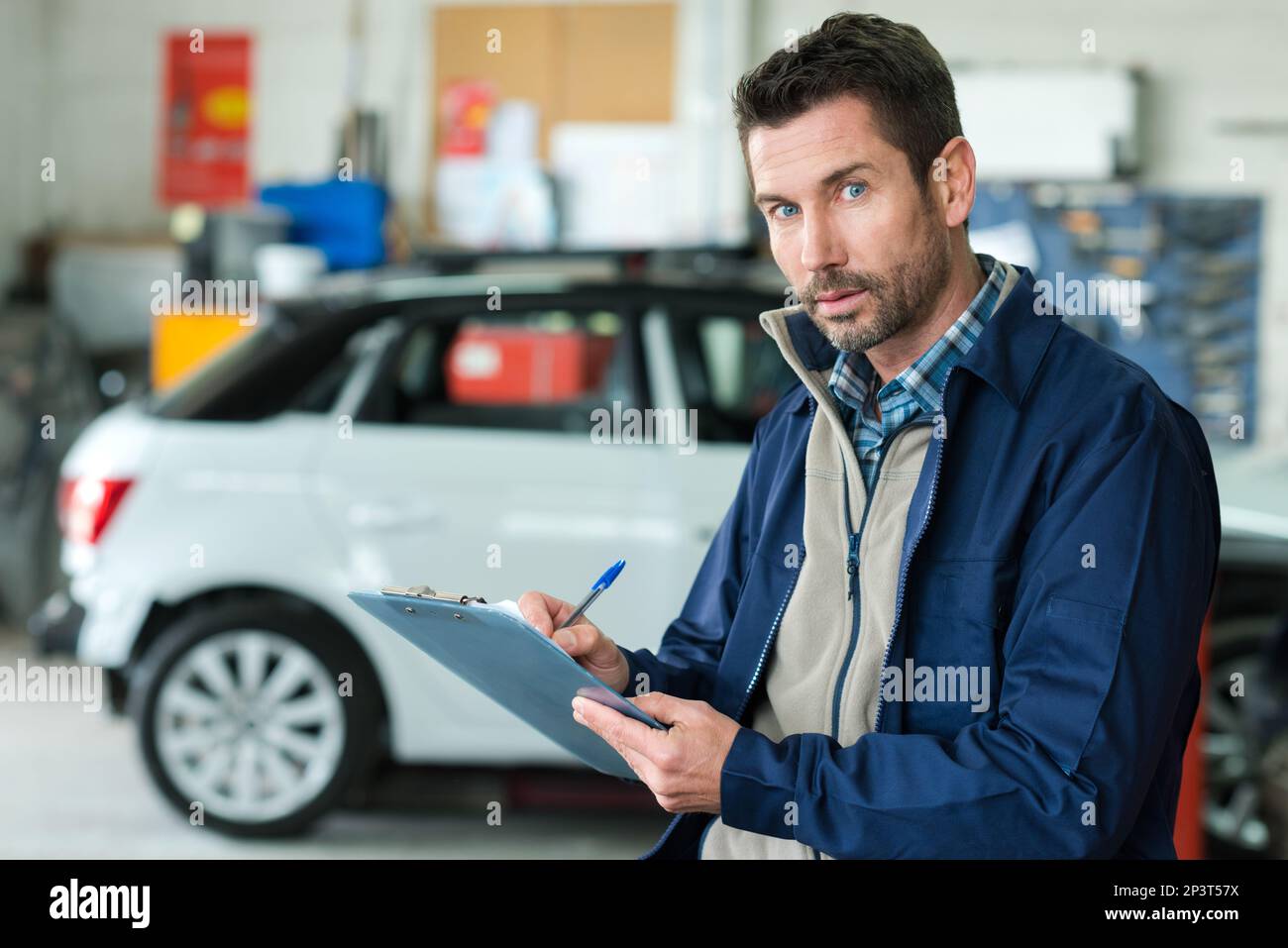 picture of mechanic doing a quotation Stock Photo - Alamy