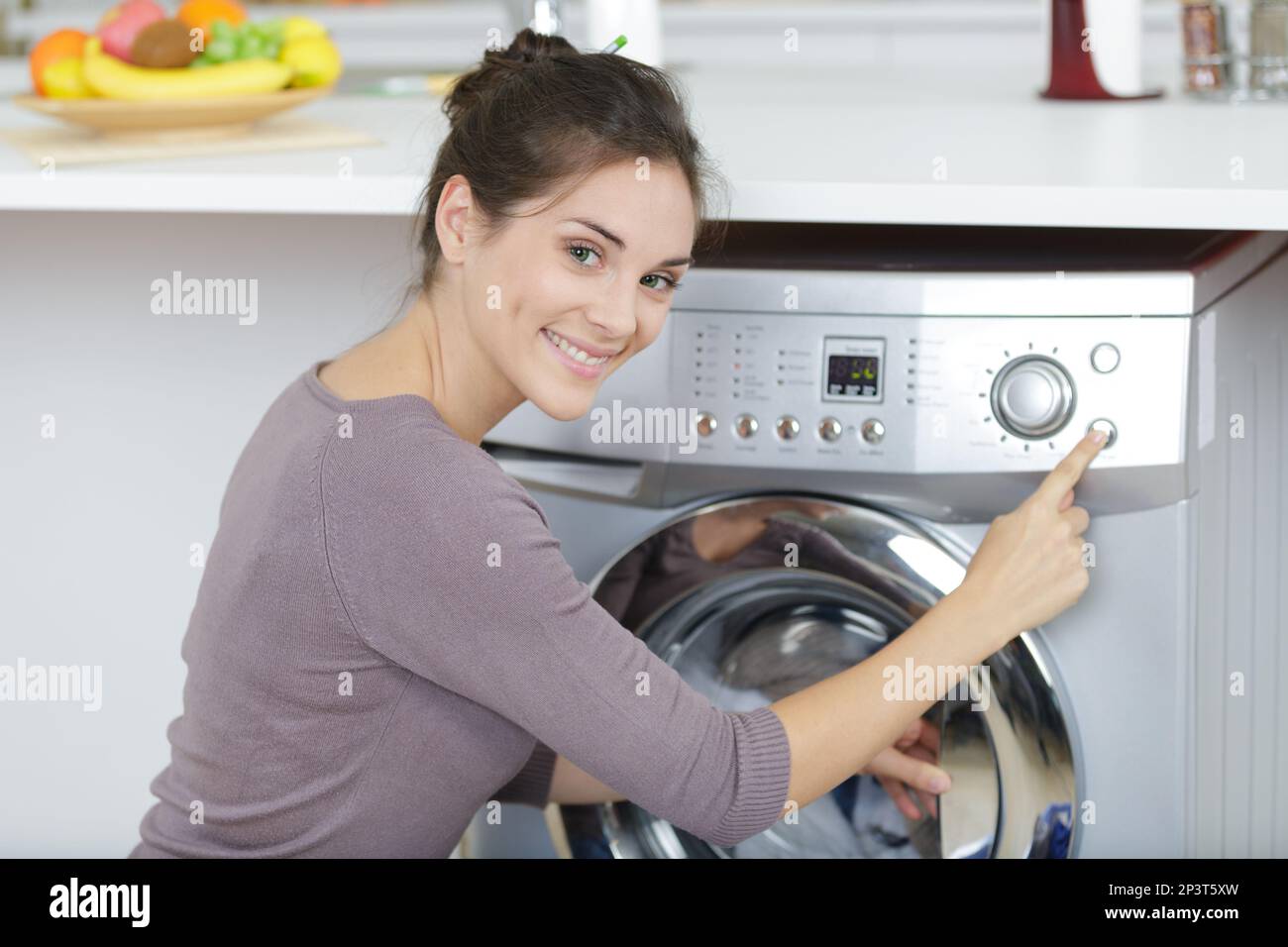 a woman using washing machine Stock Photo - Alamy