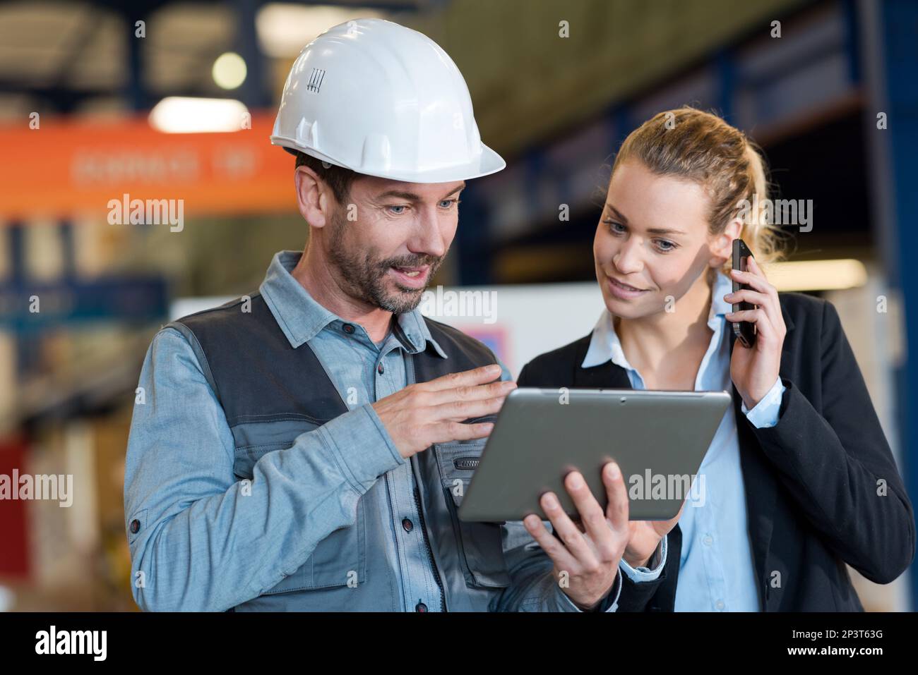 factory manager showing the huge order on the website Stock Photo - Alamy