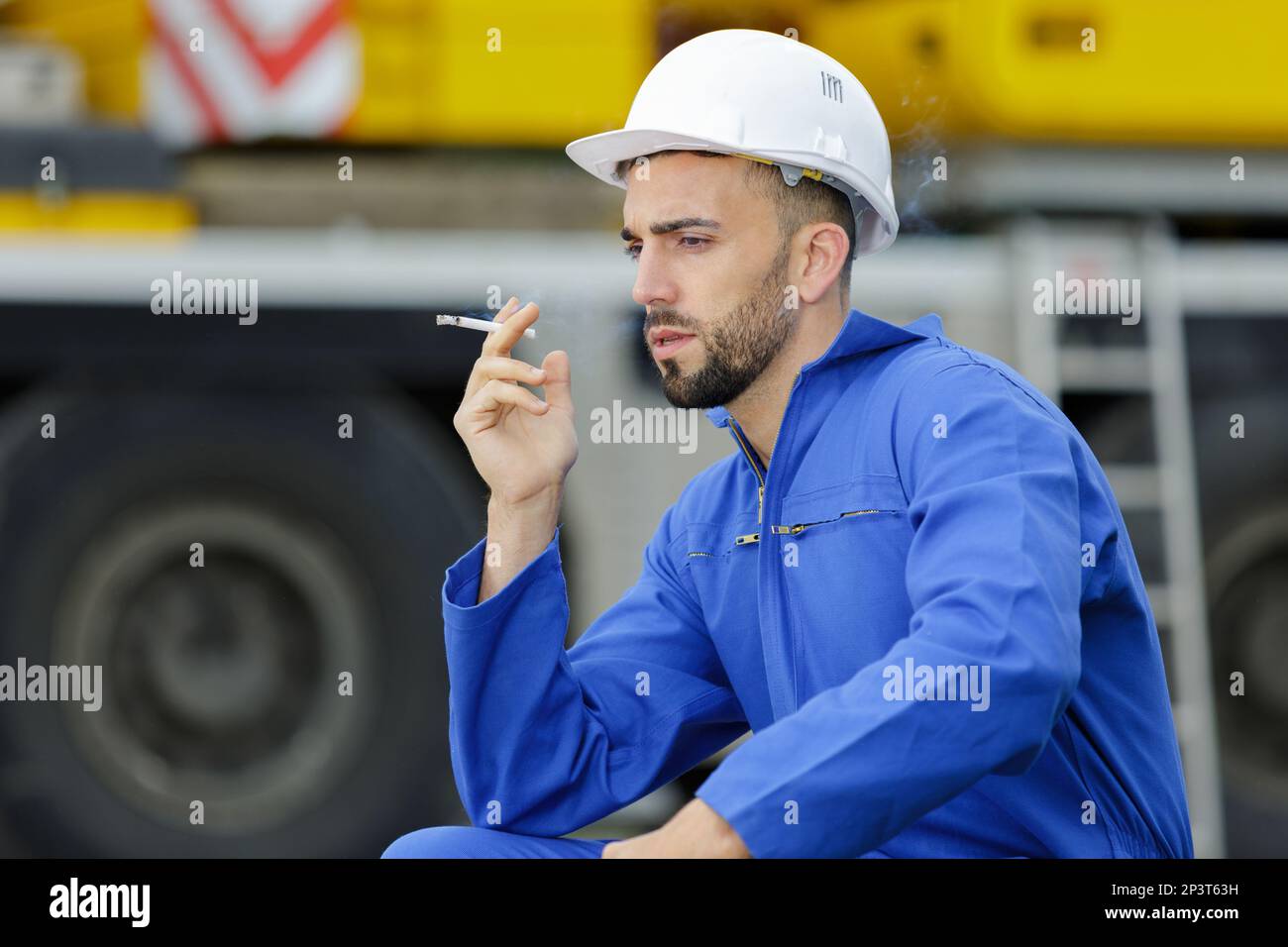 Worker smoking cigarette outdoors hi-res stock photography and images ...
