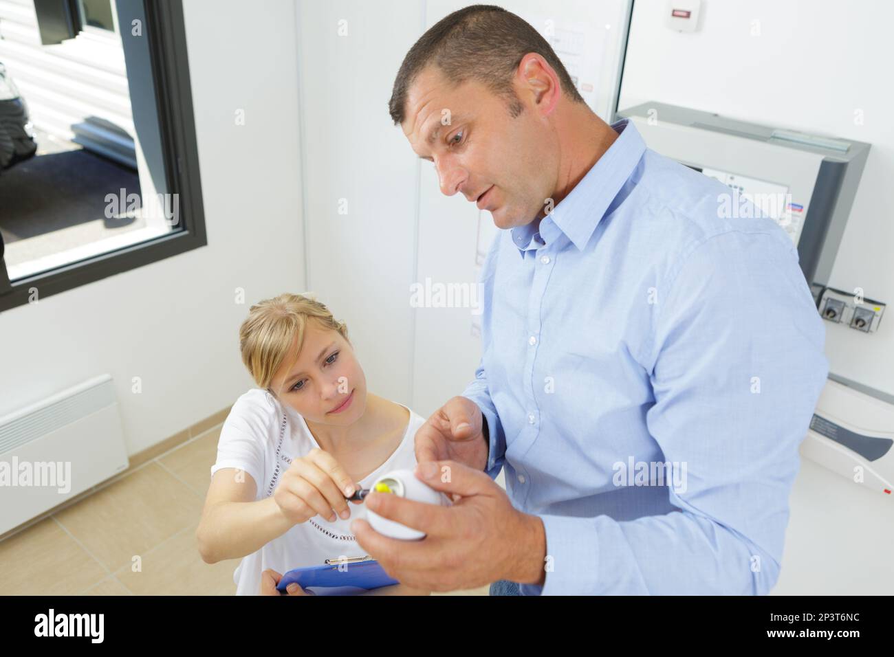 inspector testing appliances in business premises Stock Photo - Alamy