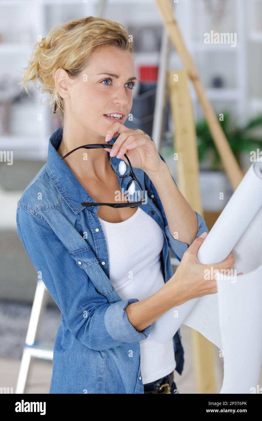 Woman unrolling sheet paper hi-res stock photography and images - Alamy