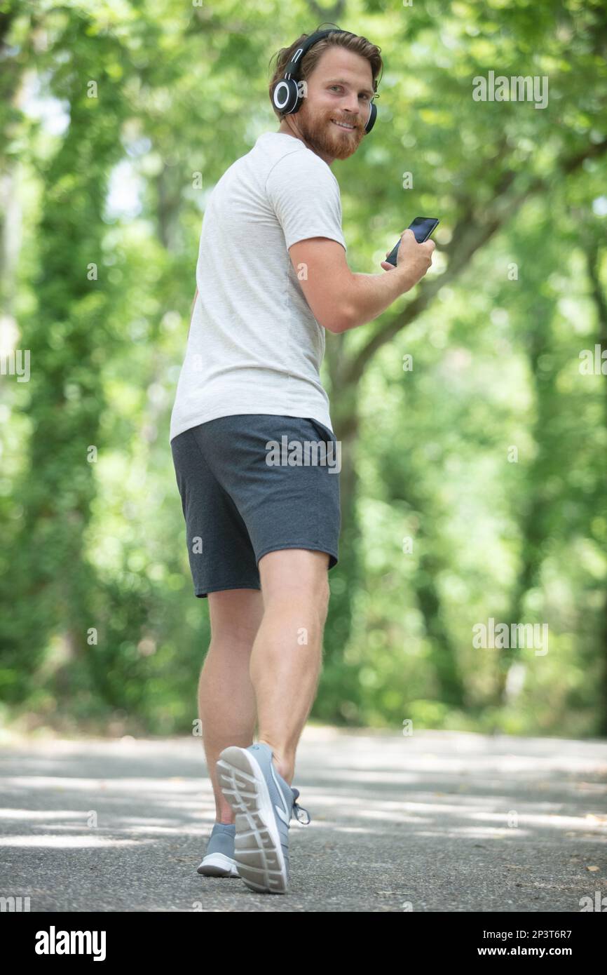 rear view of male jogger wearing headphones Stock Photo - Alamy