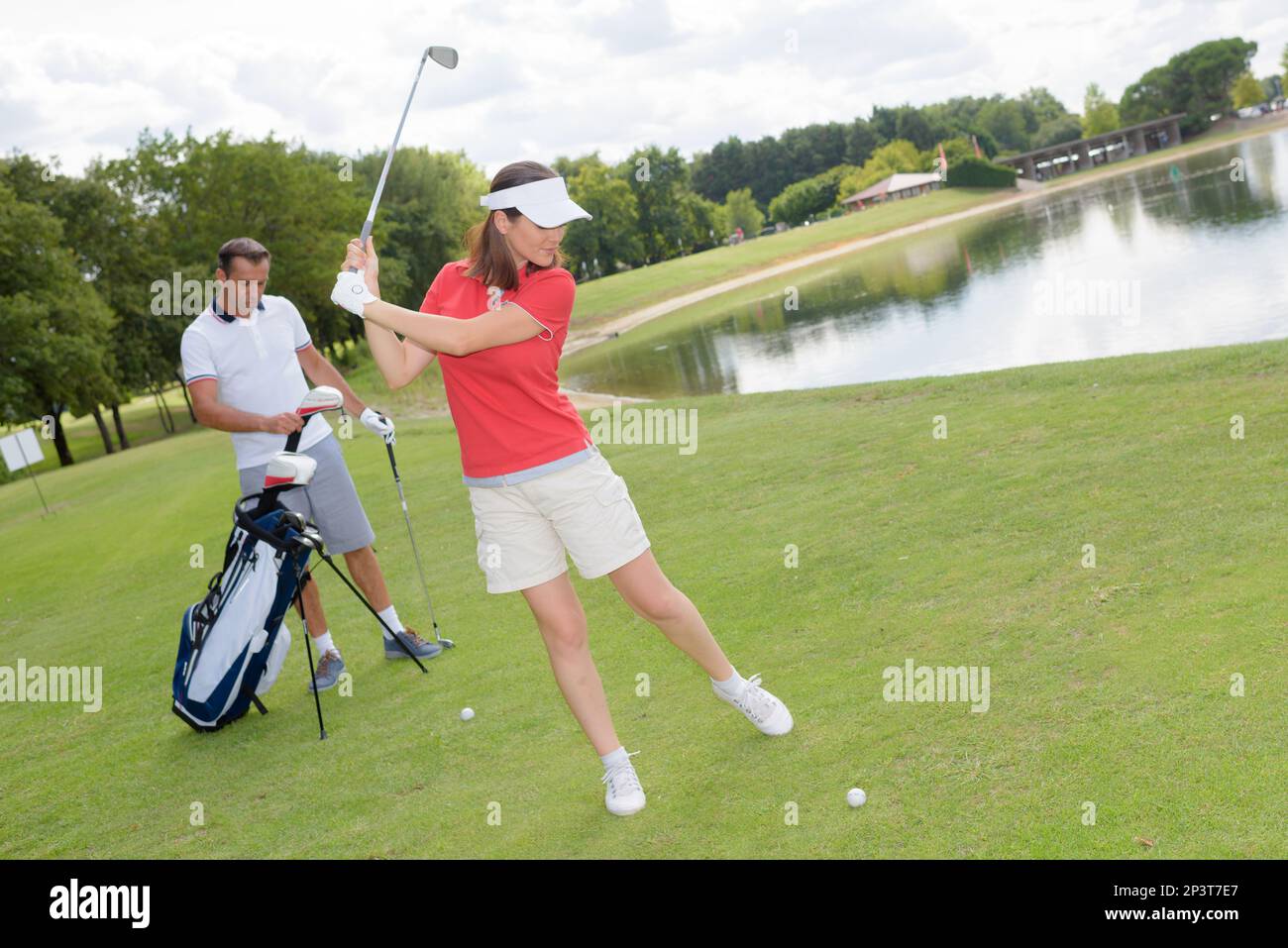 two young golfers standing on golf course Stock Photo - Alamy
