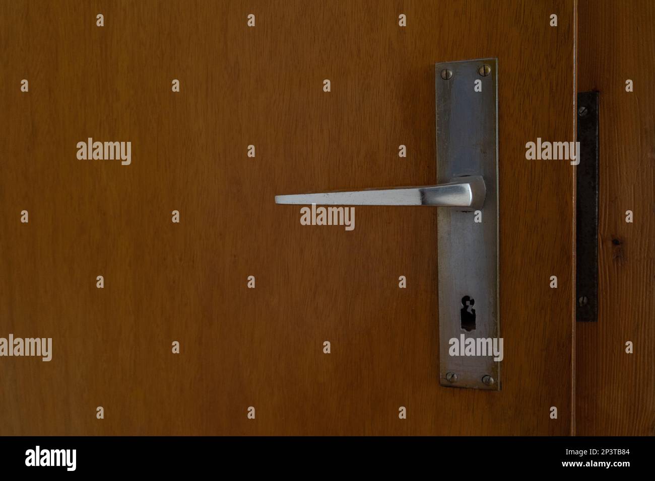 Old used door handle on a brown wooden door in a apartment Stock Photo ...