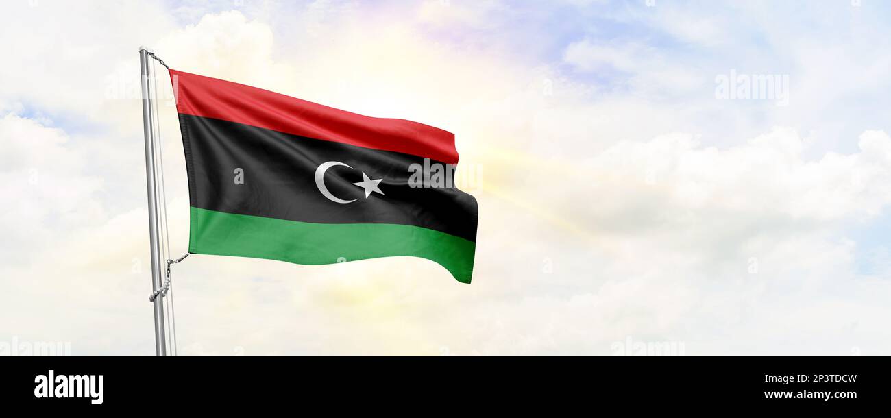 Libya flag waving on sky background. 3D Rendering Stock Photo - Alamy