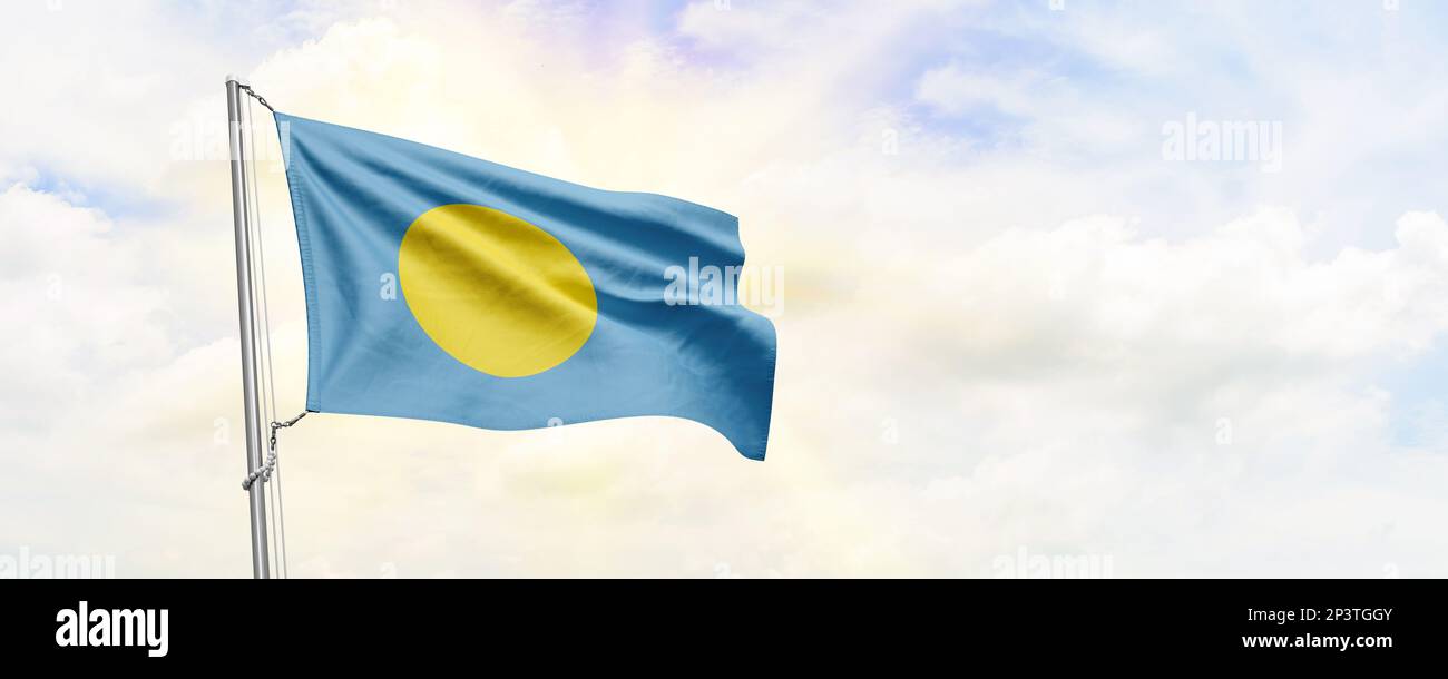 Palau flag waving on sky background. 3D Rendering Stock Photo - Alamy