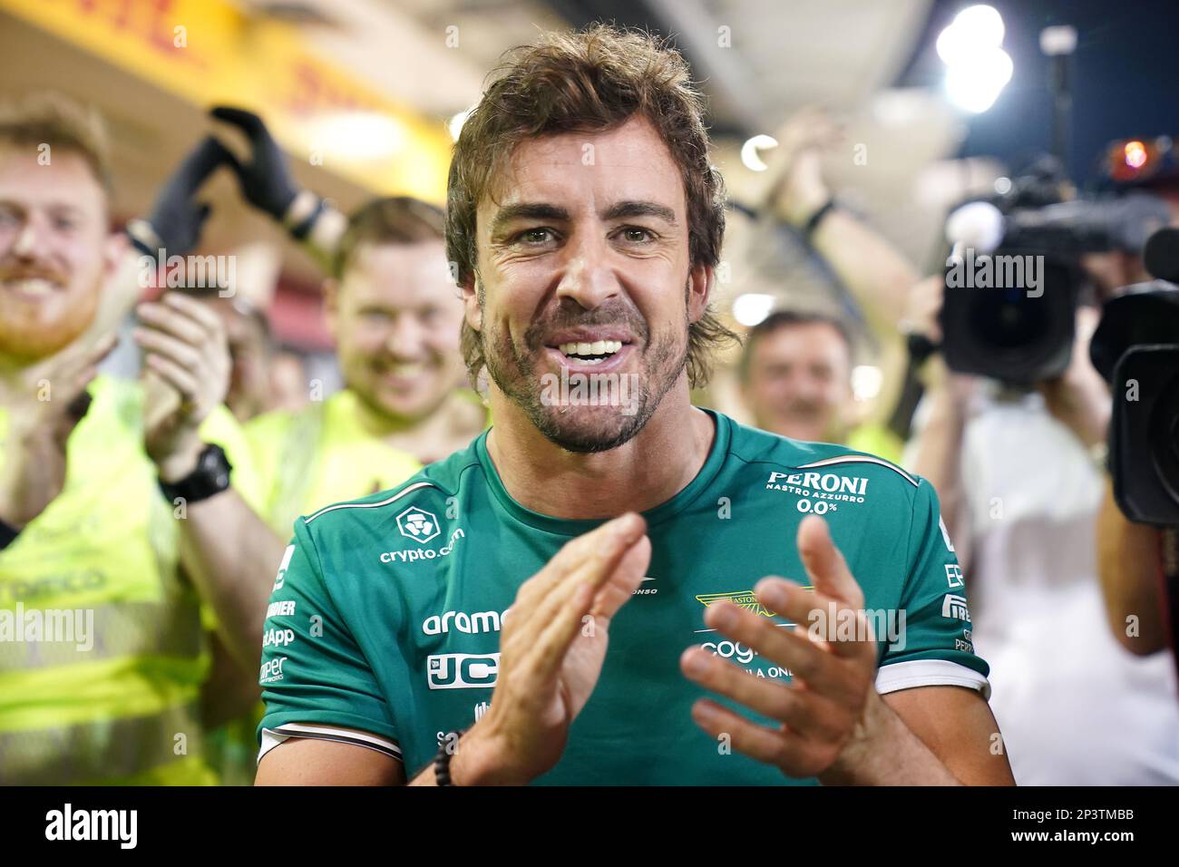 Aston Martin's Fernando Alonso celebrates with his team after finishing ...
