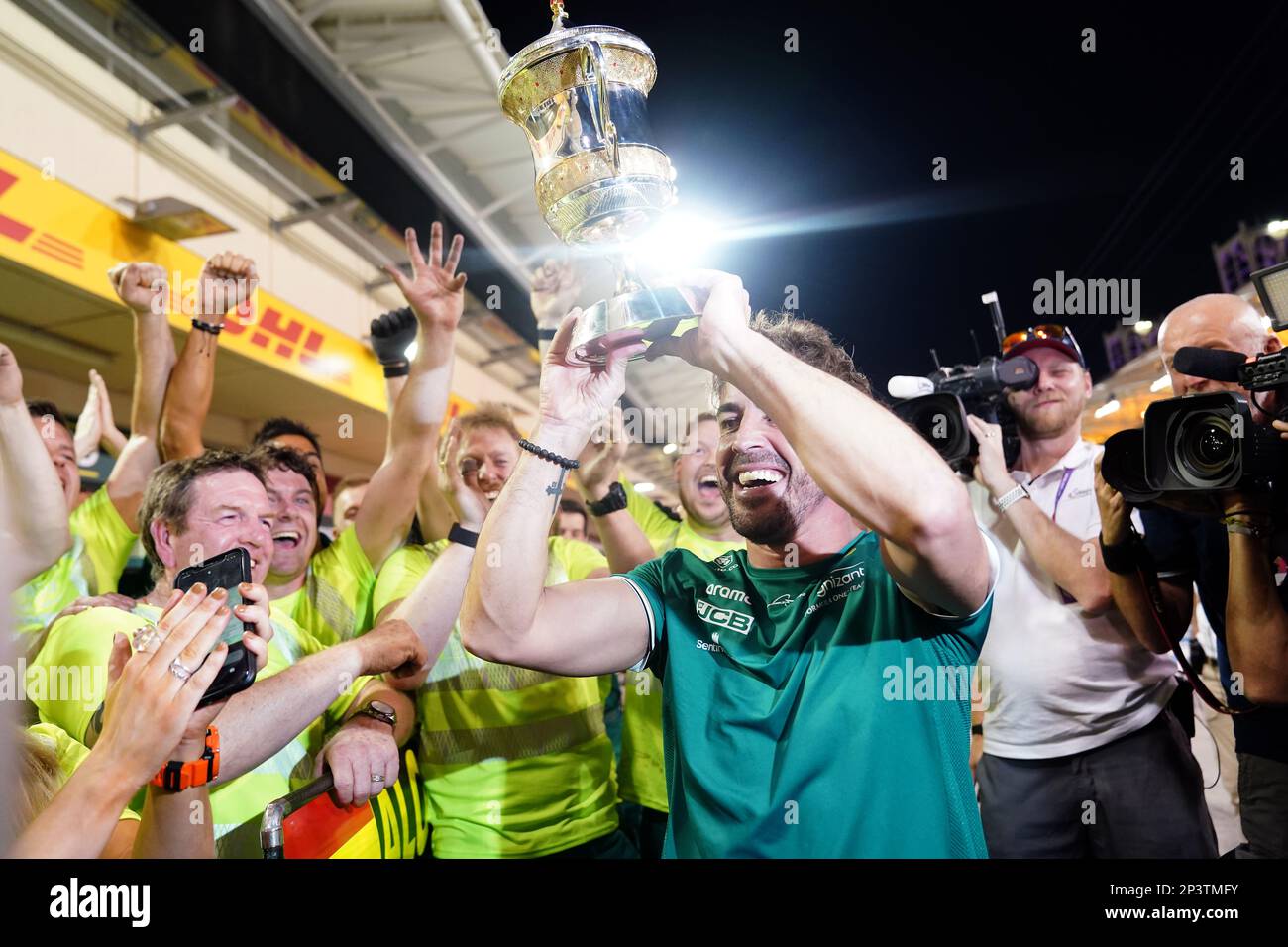 Aston Martin's Fernando Alonso celebrates with the trophy and team ...