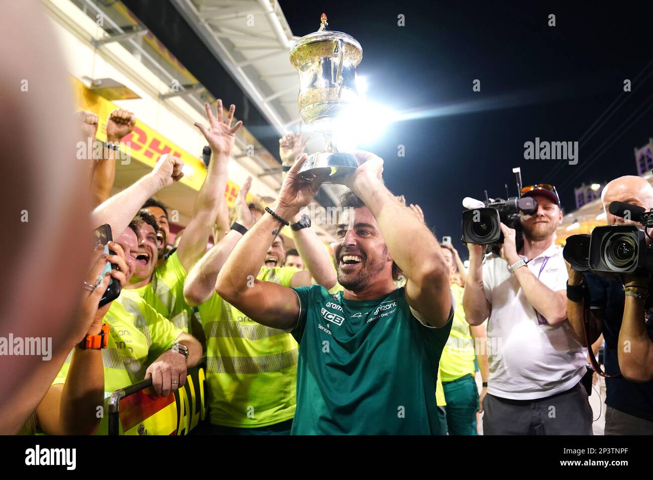 Aston Martin's Fernando Alonso celebrates with the trophy and team ...