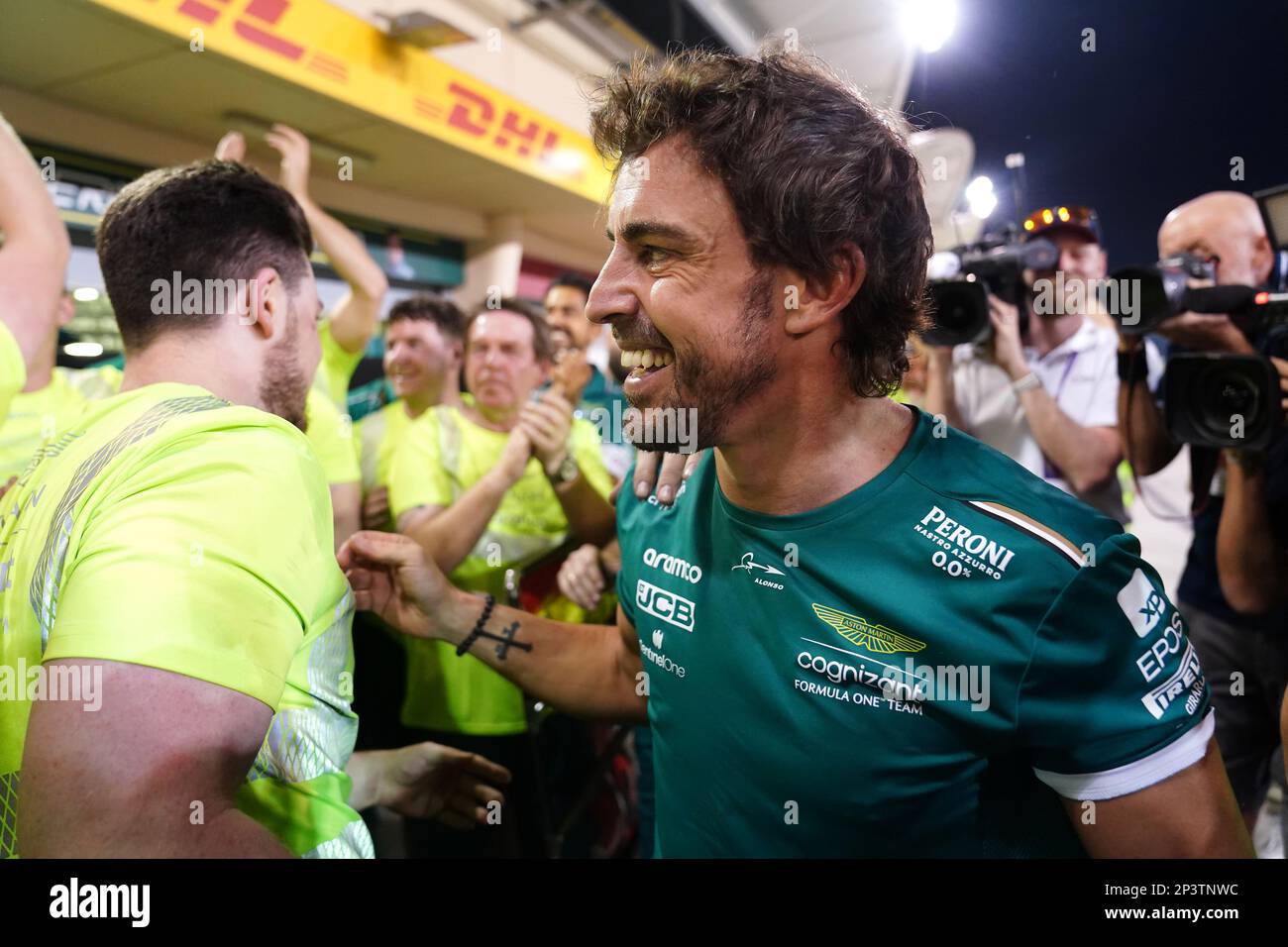 Aston Martin's Fernando Alonso celebrates with his team after finishing ...