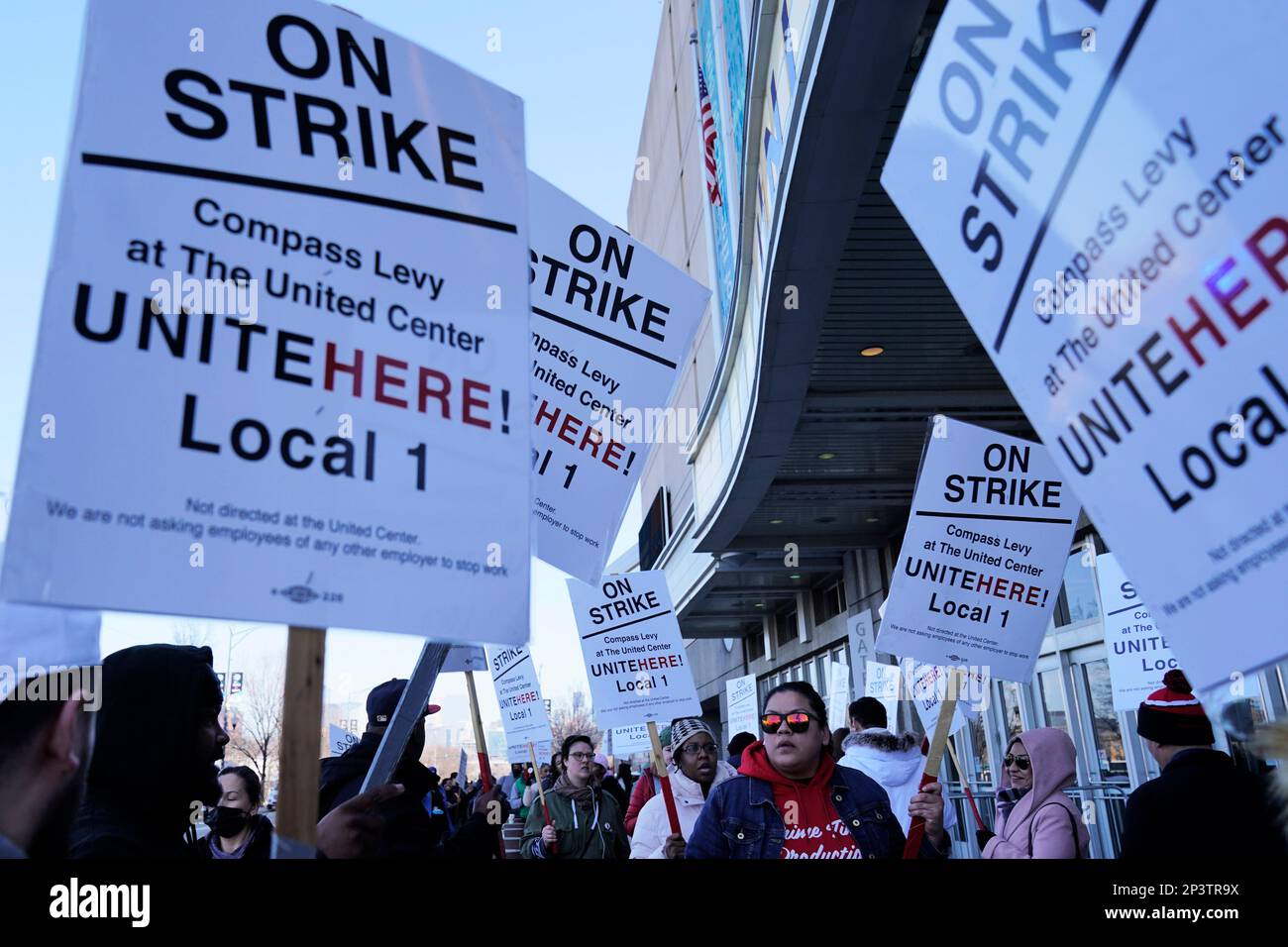 Workers hold signs at United Center in Chicago, Sunday, March 5, 2023 ...