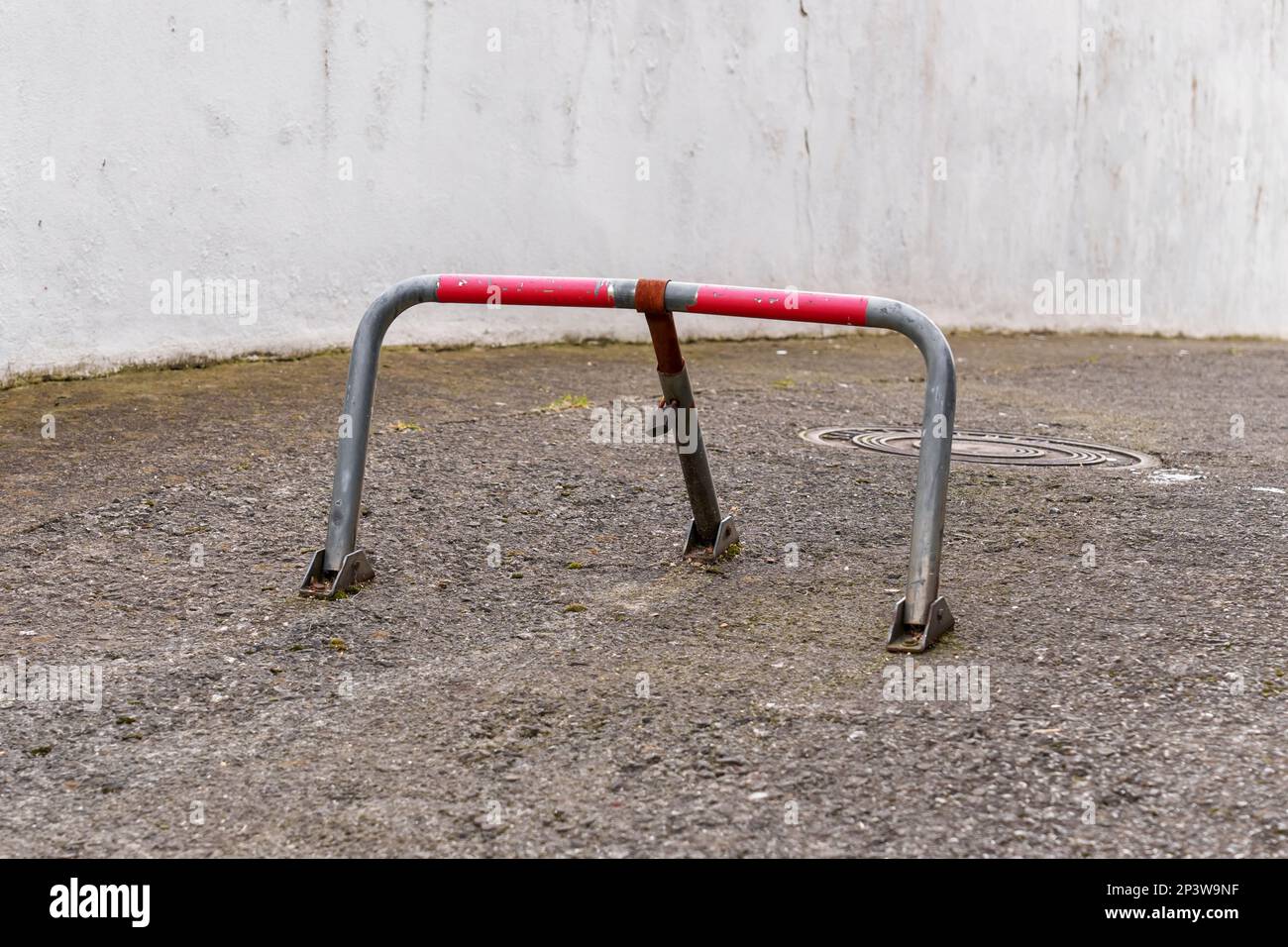Parking metal blocker for a reserved closed car space Stock Photo - Alamy